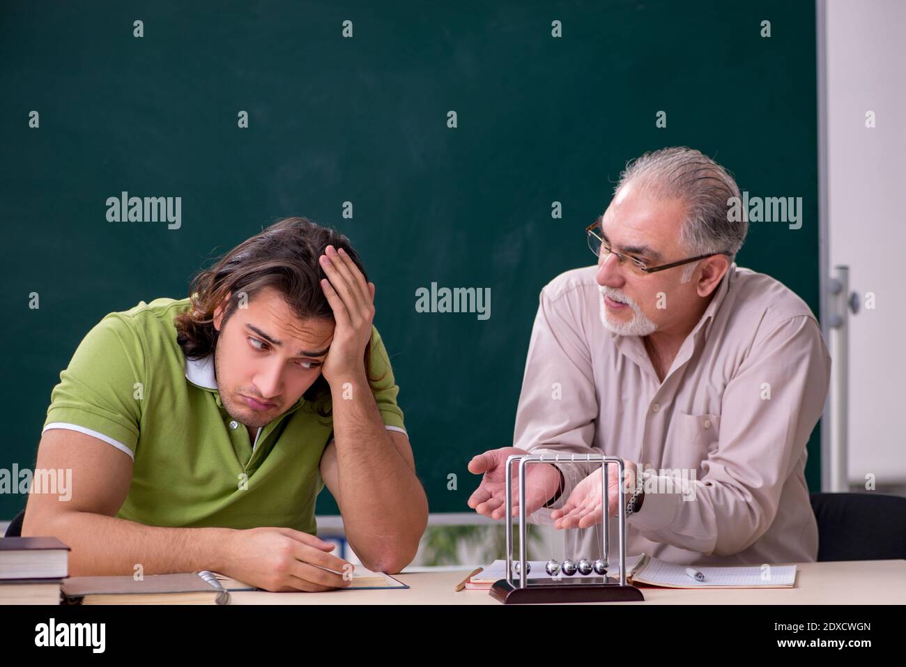 Old professor physicist and student in the classroom Stock Photo - Alamy