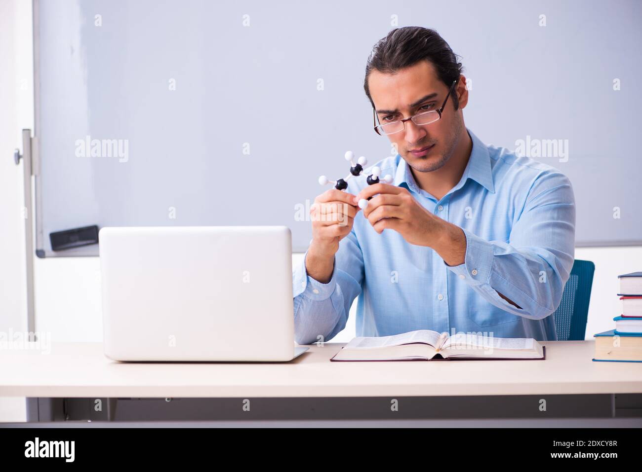 Young physics teacher in front of whiteboard Stock Photo - Alamy