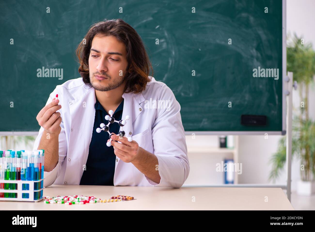 Young scientist sitting in the classroom Stock Photo - Alamy