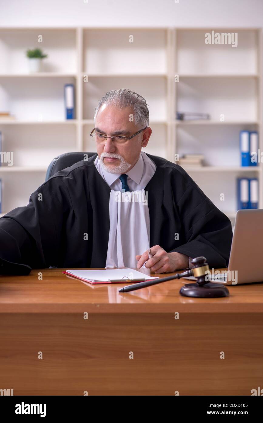 Old male judge working in the courthouse Stock Photo - Alamy