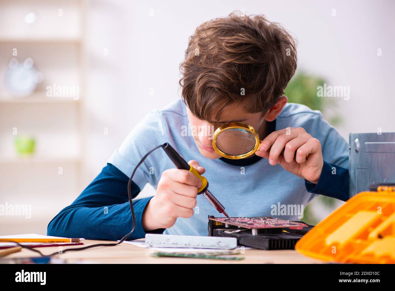 Teenager reparing computers at workshop Stock Photo - Alamy