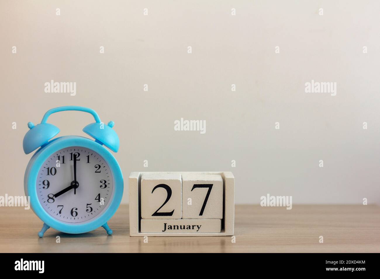 January 27 on a white calendar, next to a retro alarm clock on a light ...