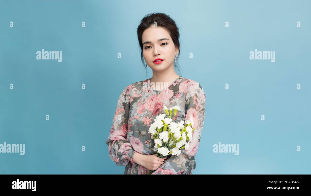 Portrait of charming female with bunch of fresh flowers Stock Photo - Alamy