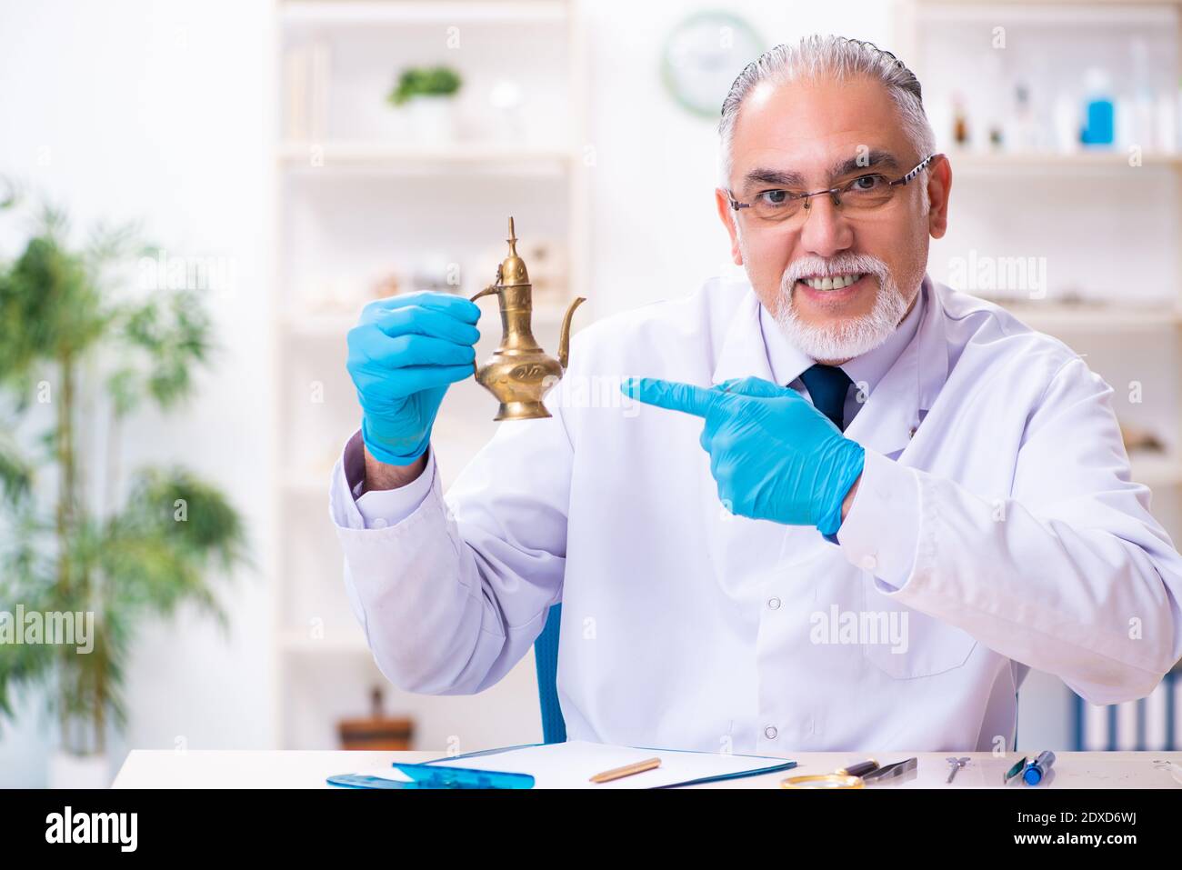 Old male archaeologist working in the lab Stock Photo - Alamy