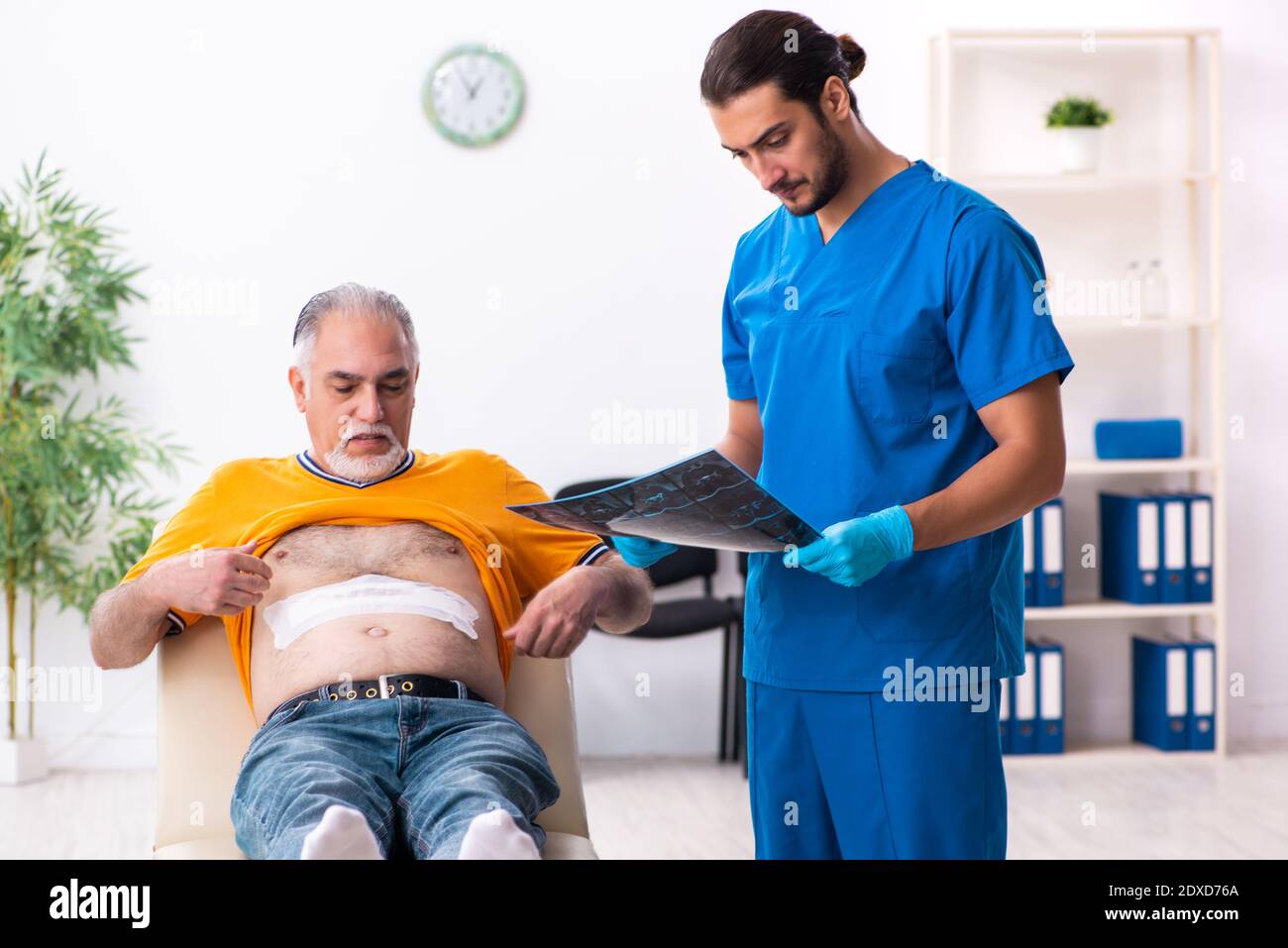 Old man visiting male doctor Stock Photo - Alamy