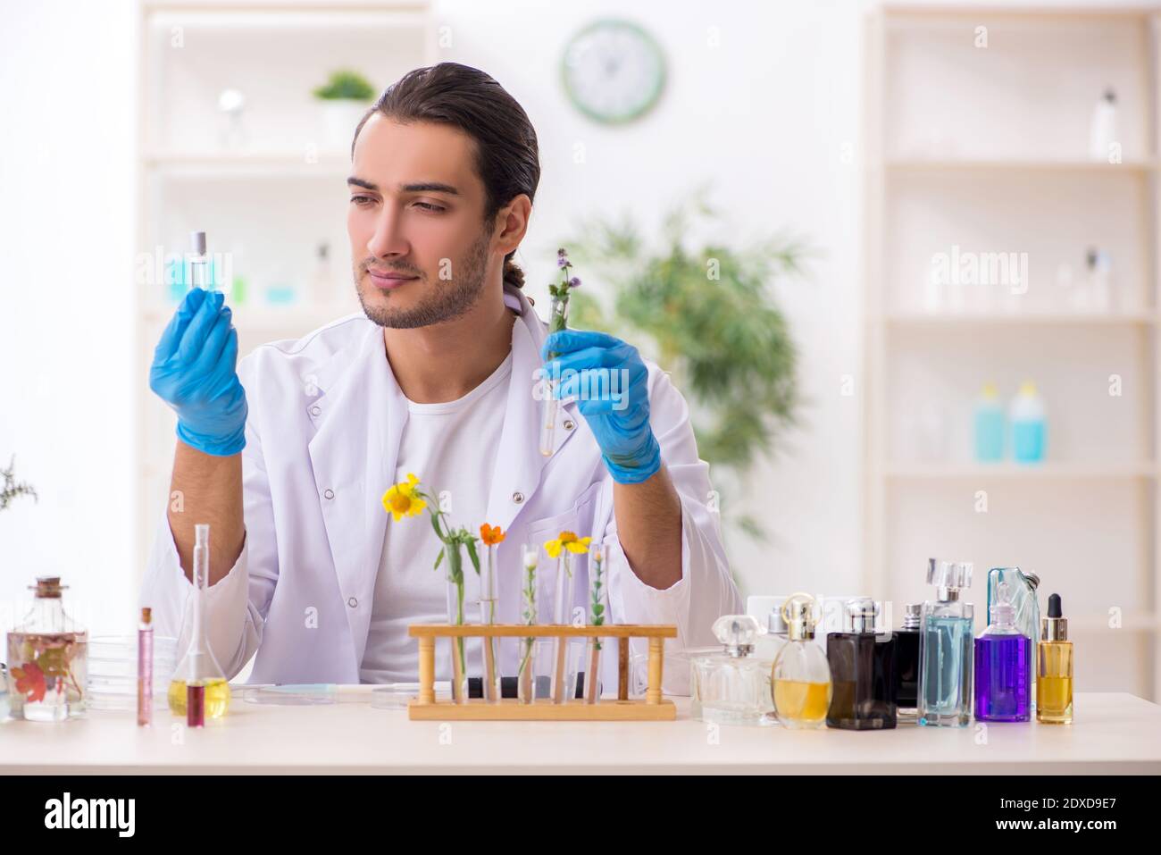 Young chemist in perfume synthesis concept Stock Photo - Alamy
