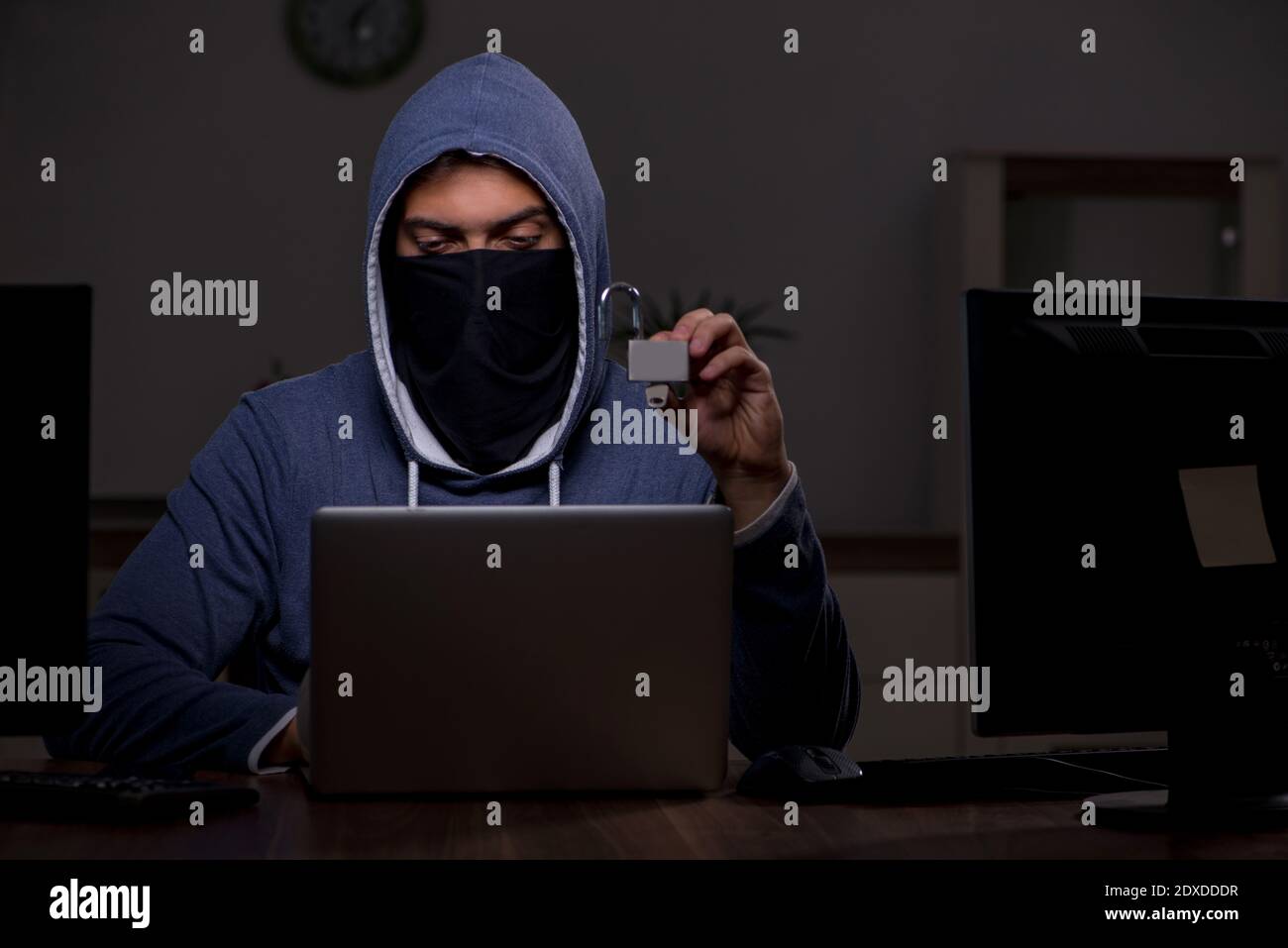 Male hacker hacking security firewall late in the office Stock Photo ...