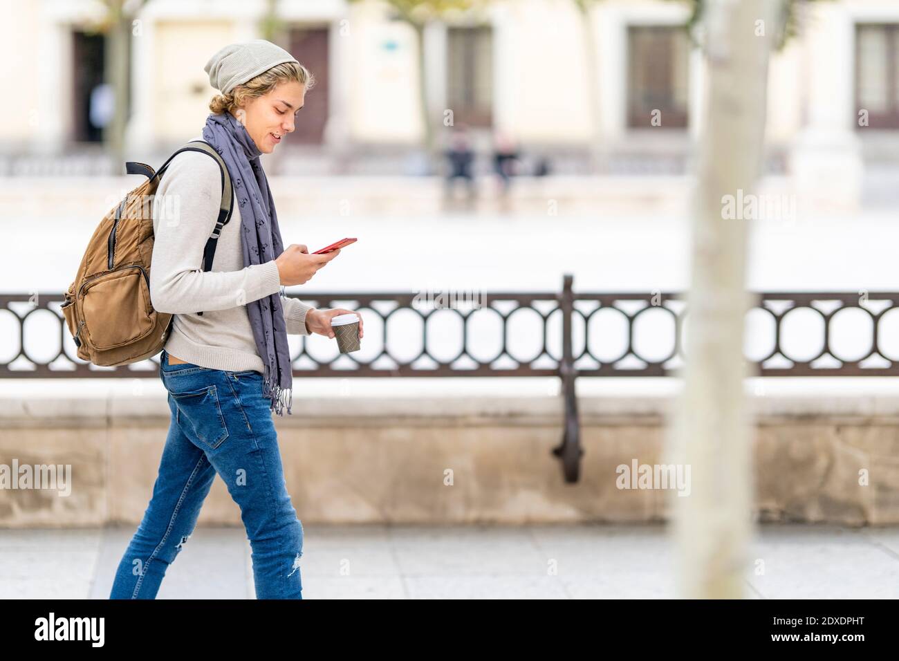Man walking and using mobile phone hi-res stock photography and images ...