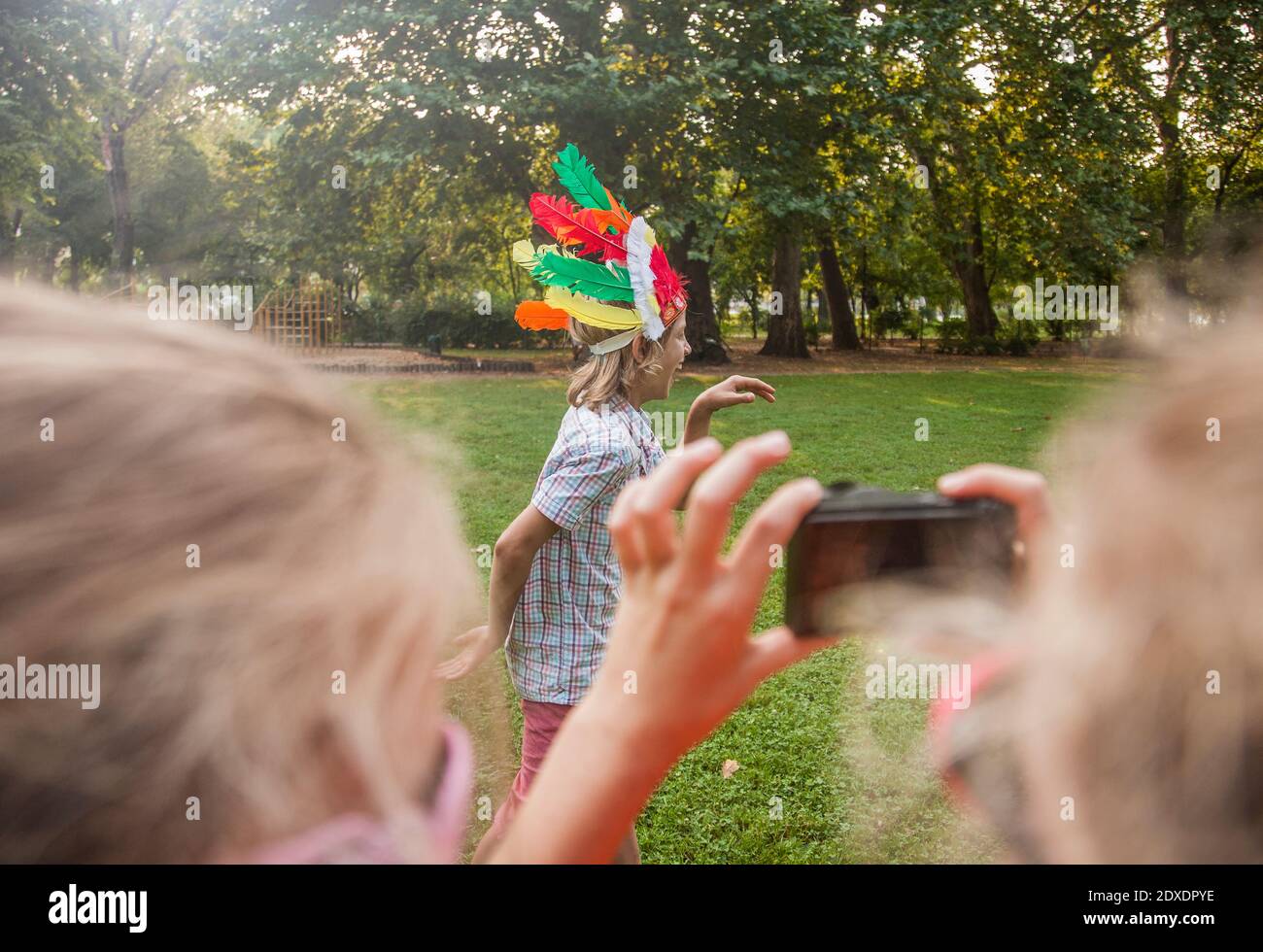 Children taking photos of each other in the park, Budapest, Hungary ...