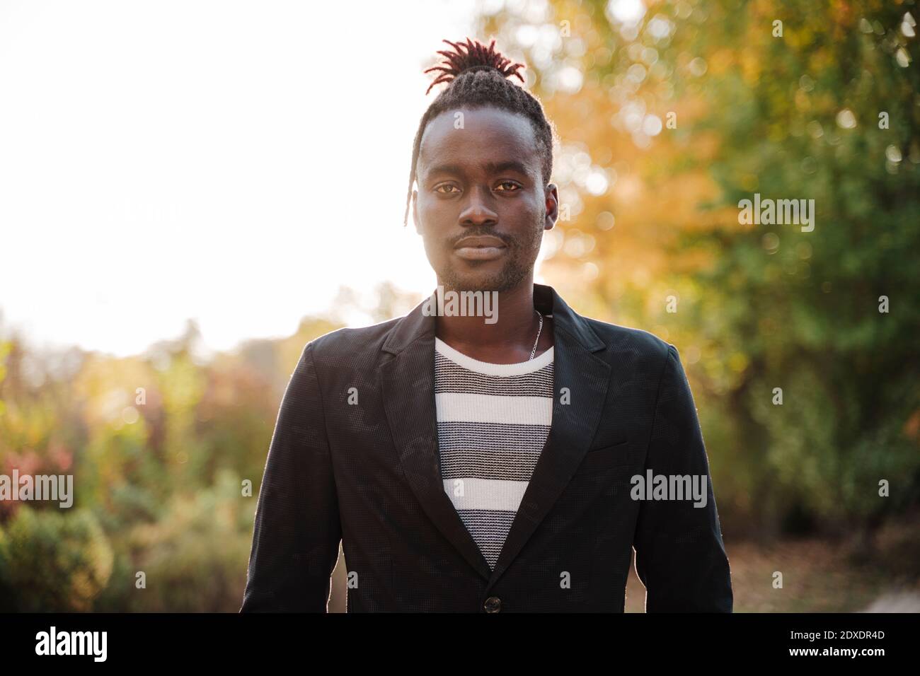 Confident young man standing outdoors hi-res stock photography and ...
