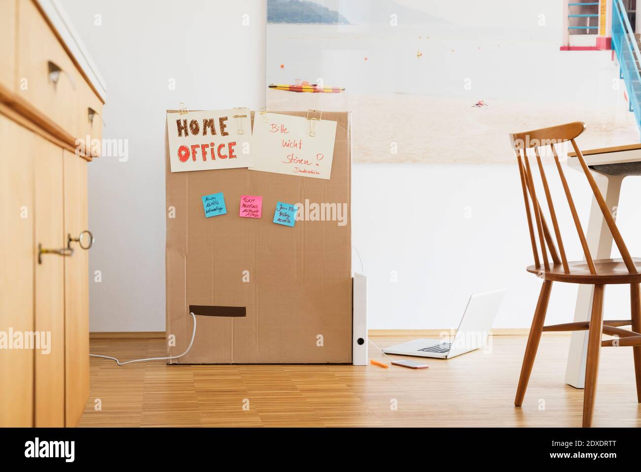Cardboard box used to create makeshift home office on dining room floor ...