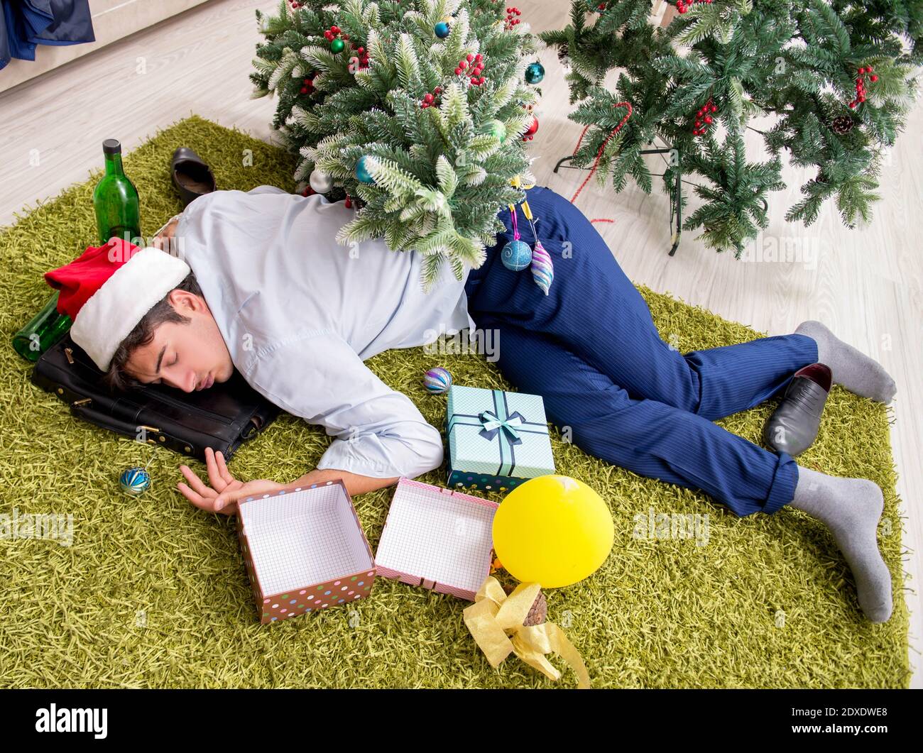 The young handsome employee celebrating christmas at workplace Stock ...