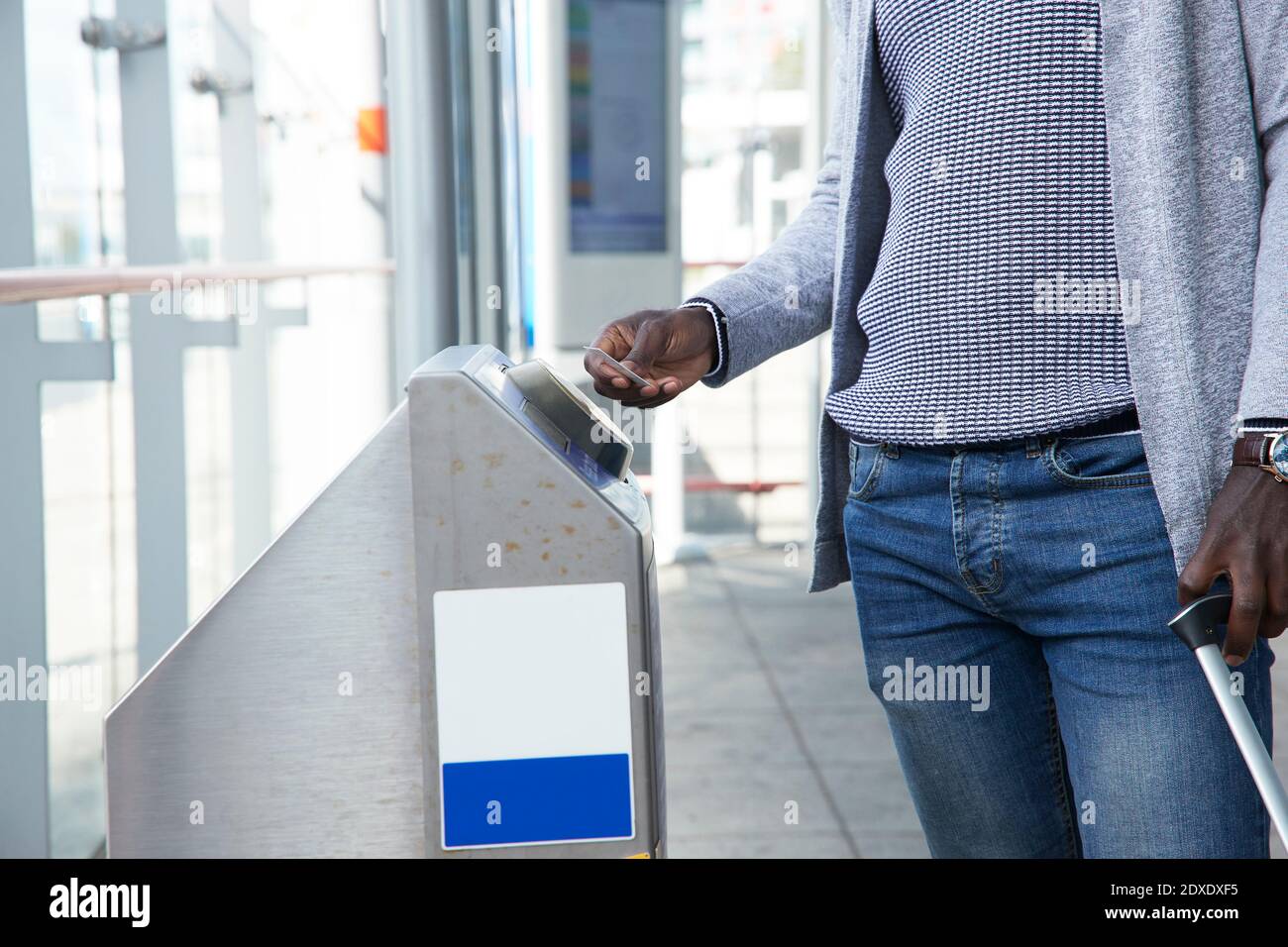 Businessman scanning ticket at gate of railroad station Stock Photo - Alamy