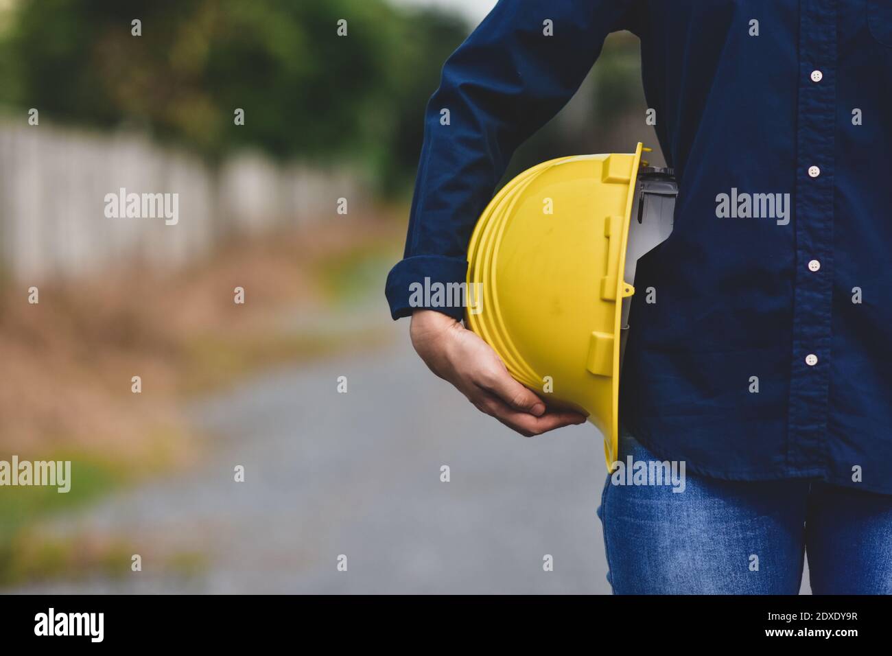 Engineering hold yellow hard hat safety work place outdoors background ...