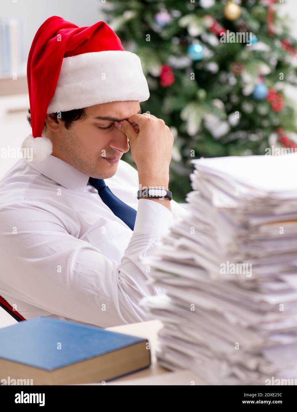 The young worker working in office on christmas shift Stock Photo - Alamy
