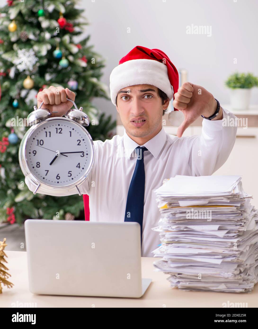The young worker working in office on christmas shift Stock Photo - Alamy