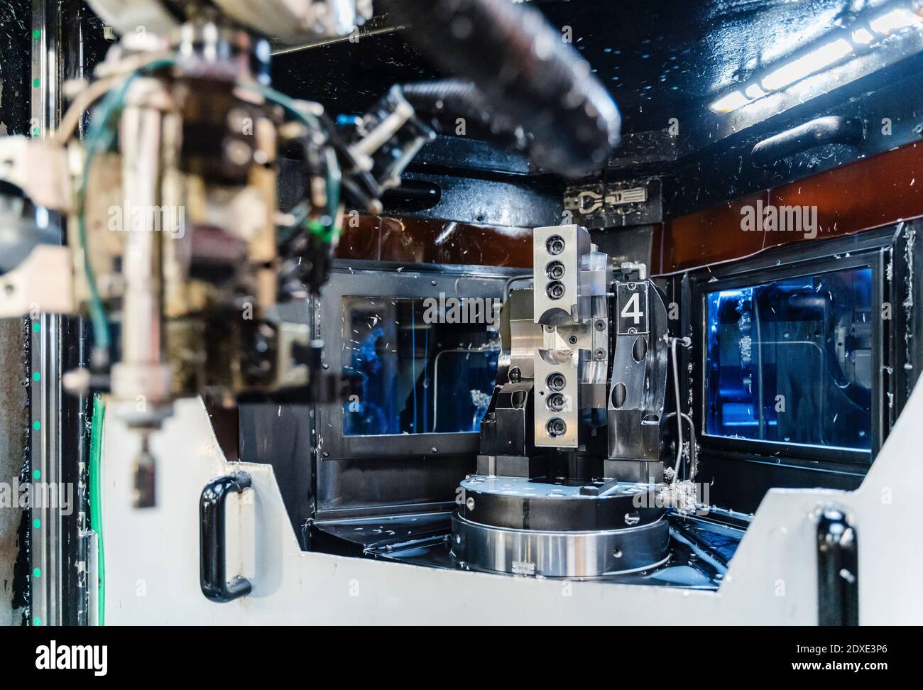 Machine system with robot at illuminated factory Stock Photo - Alamy