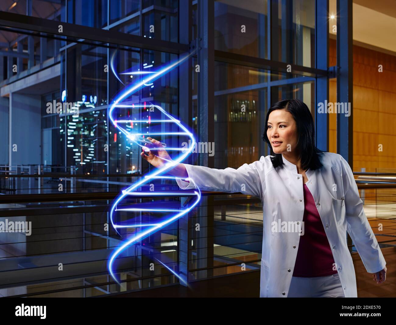 Mature female doctor light painting DNA in laboratory at hospital Stock ...