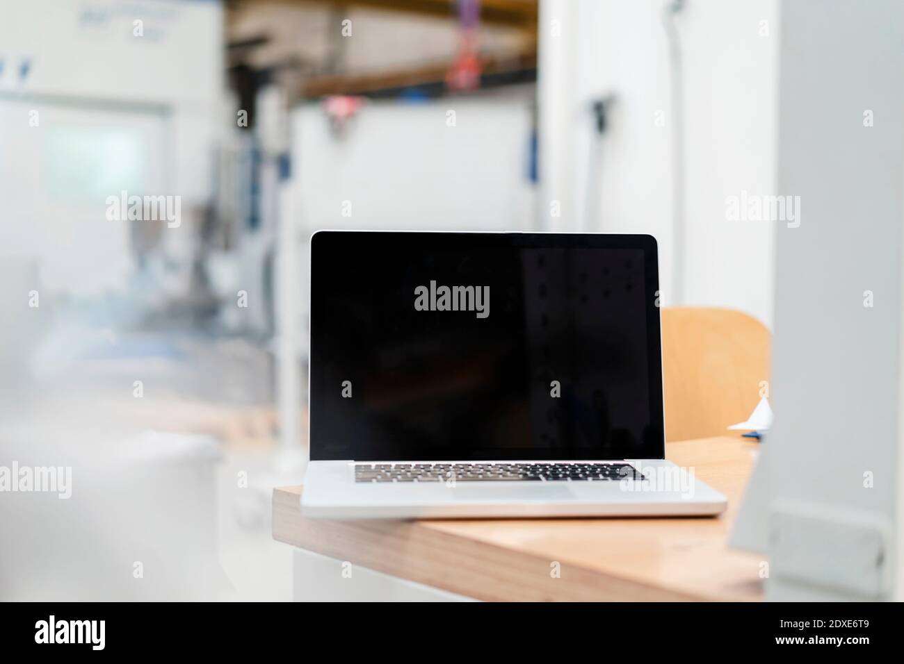 Laptop on desk at industry Stock Photo - Alamy