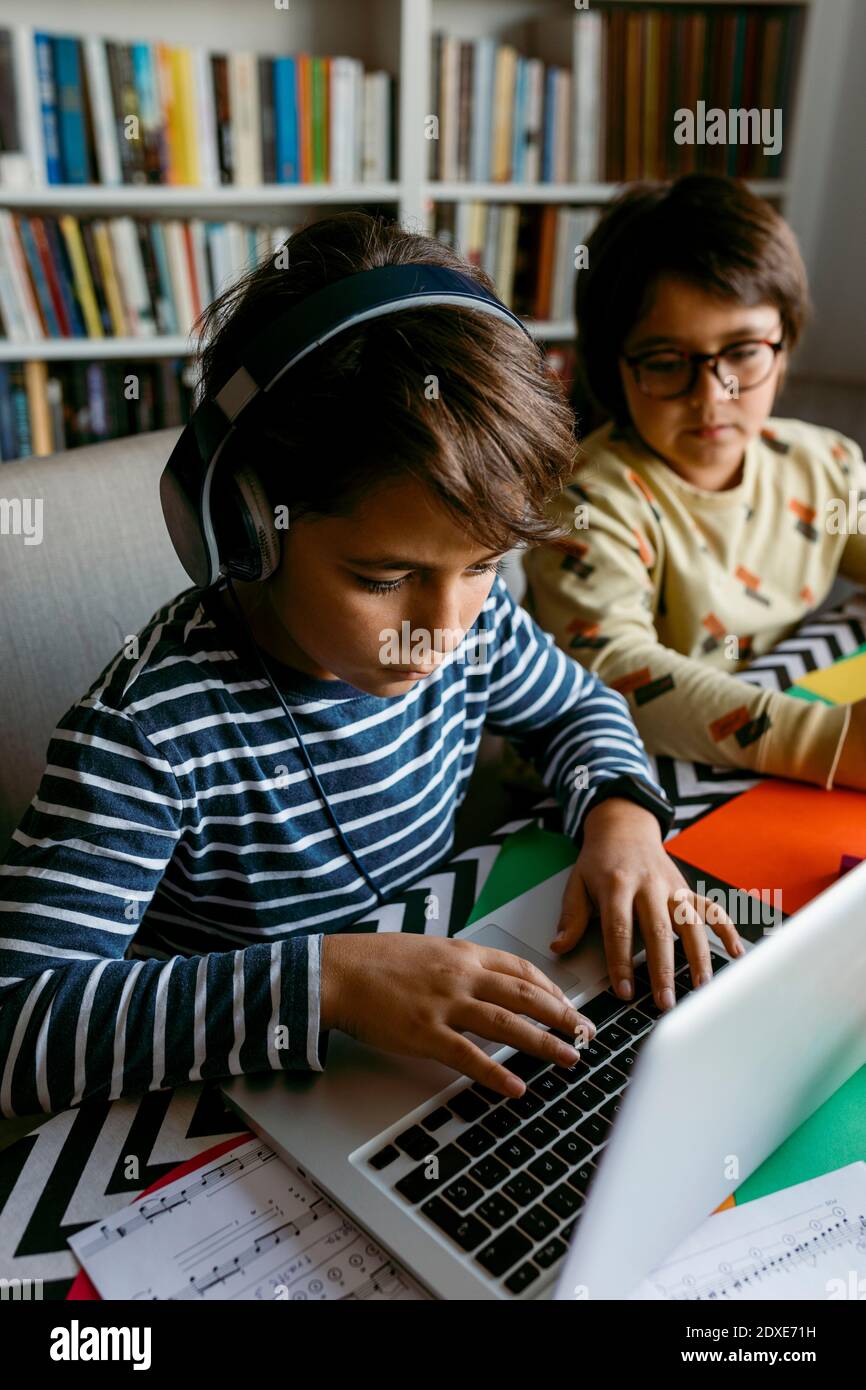 Boy sitting at computer typing hi-res stock photography and images - Alamy