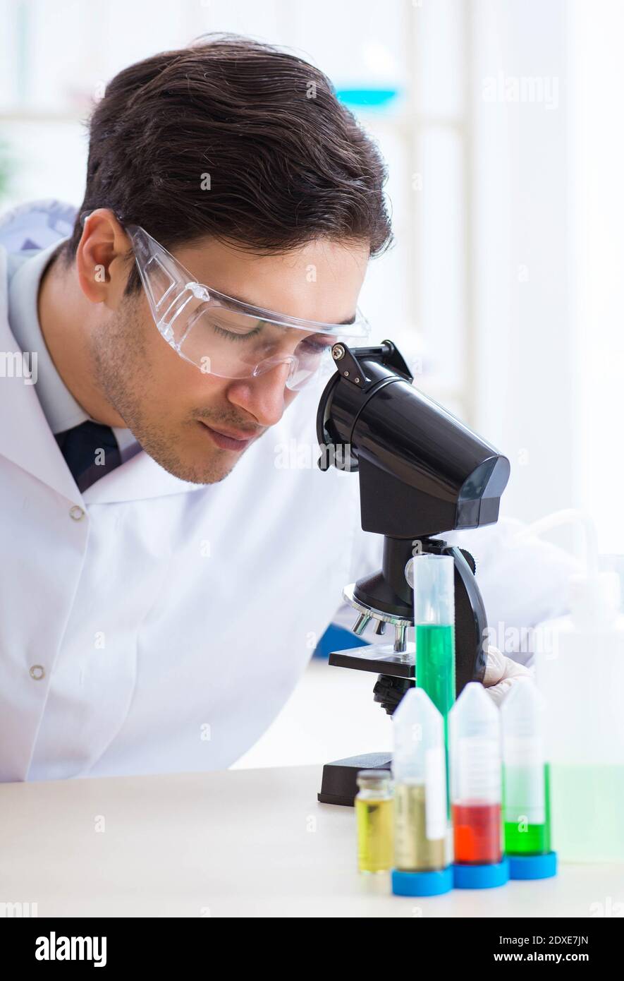 The male biochemist working in the lab on plants Stock Photo - Alamy