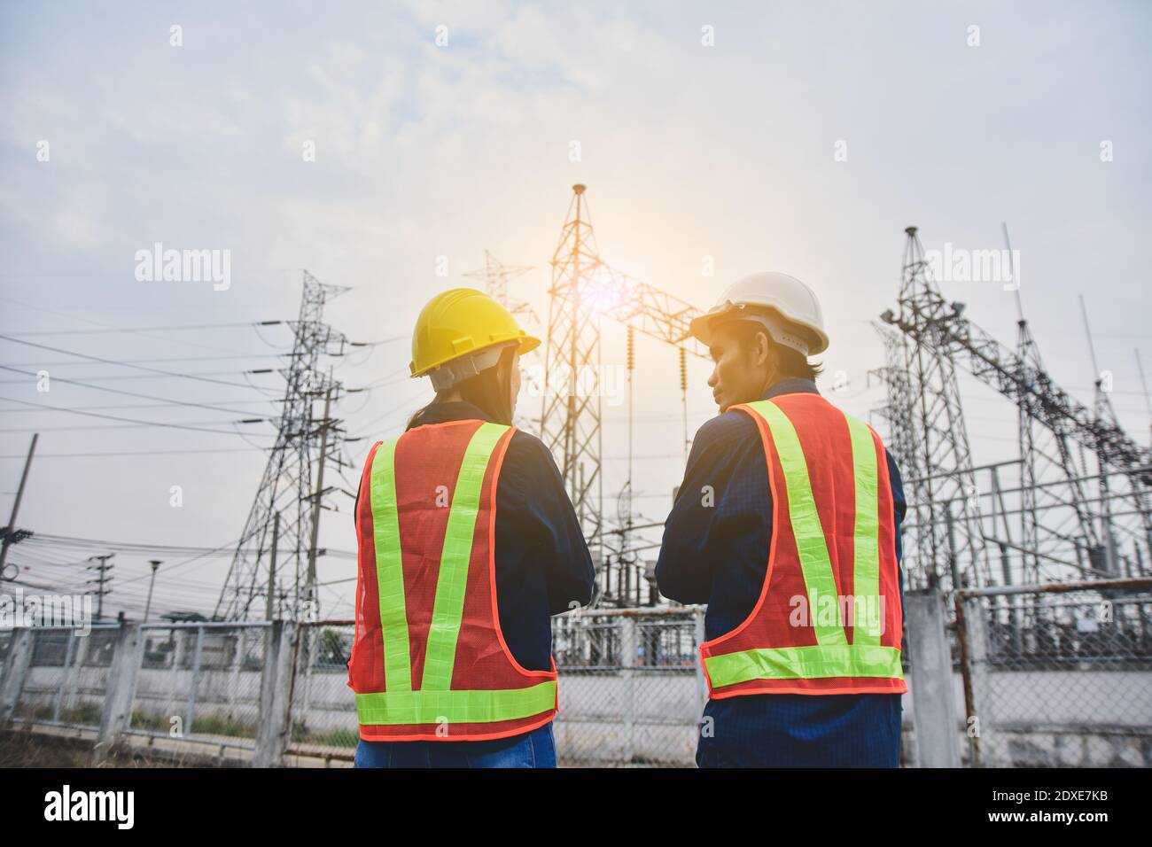 Man and Women Engineering standing communication at power plant ...