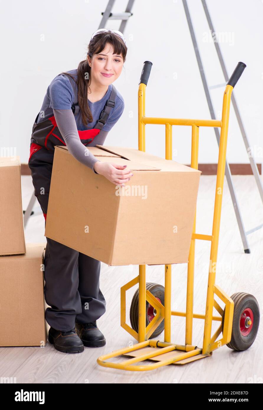 The woman contractor moving boxes in relocation concept Stock Photo - Alamy