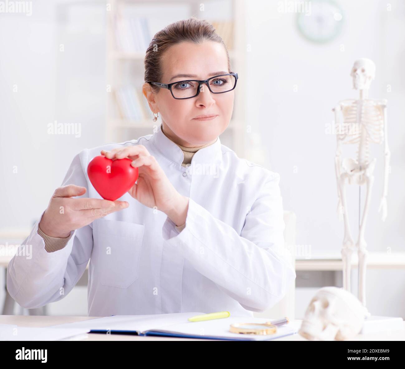 The cardiologist with red heart in medical concept Stock Photo - Alamy