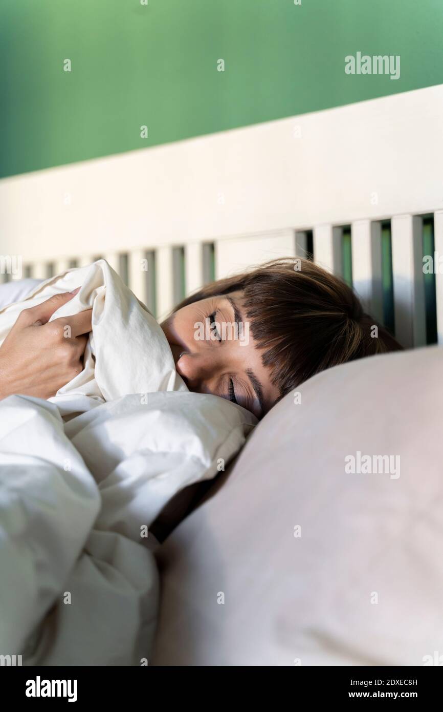 Woman sleeping on bed at home Stock Photo - Alamy