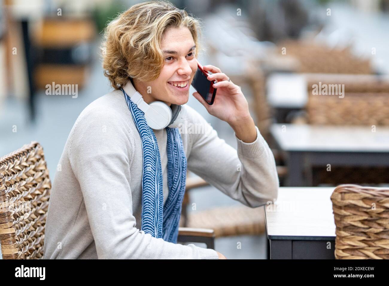 Smiling young blond man talking hi-res stock photography and images - Alamy