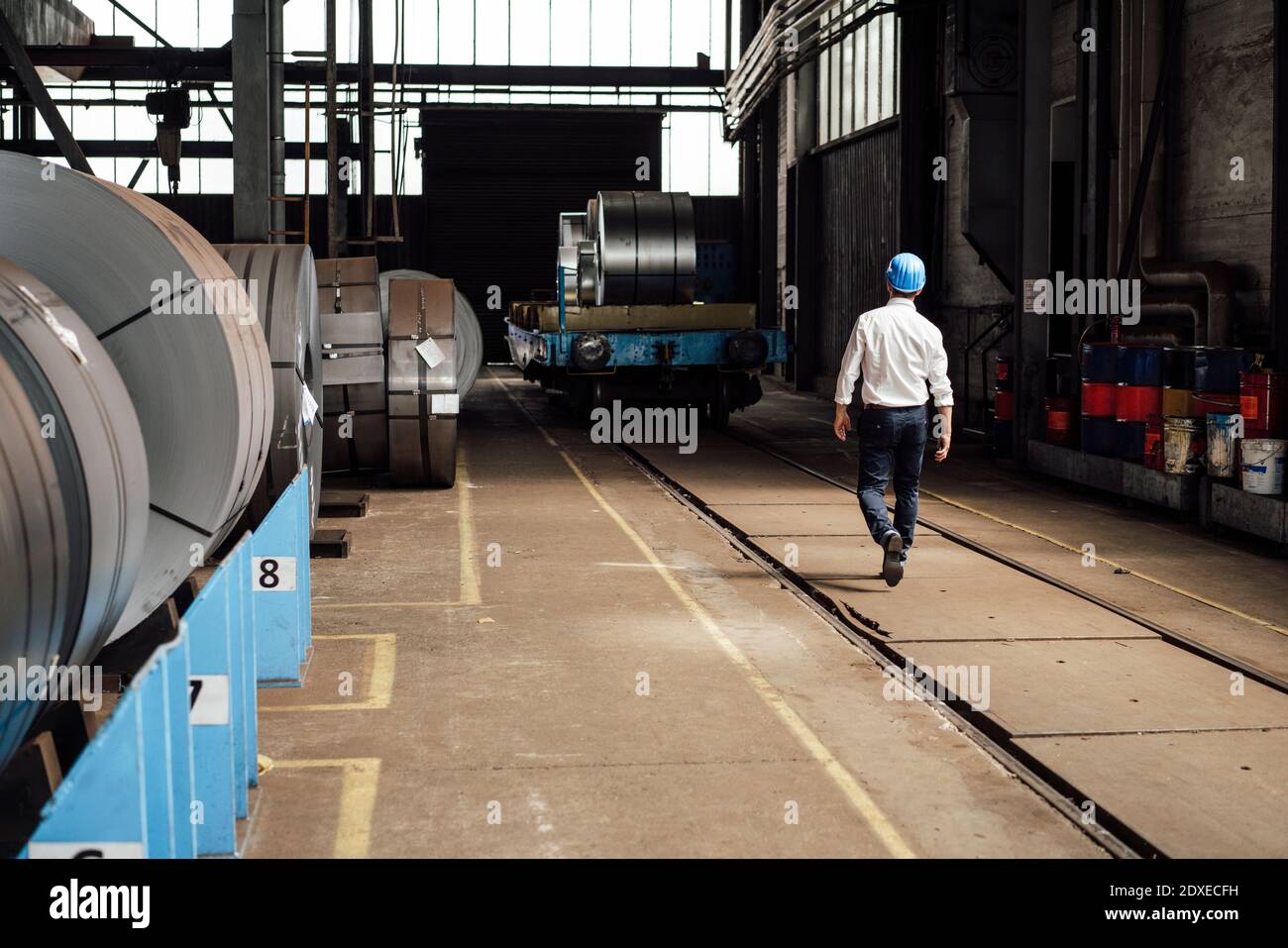 Male owner walking in factory Stock Photo - Alamy