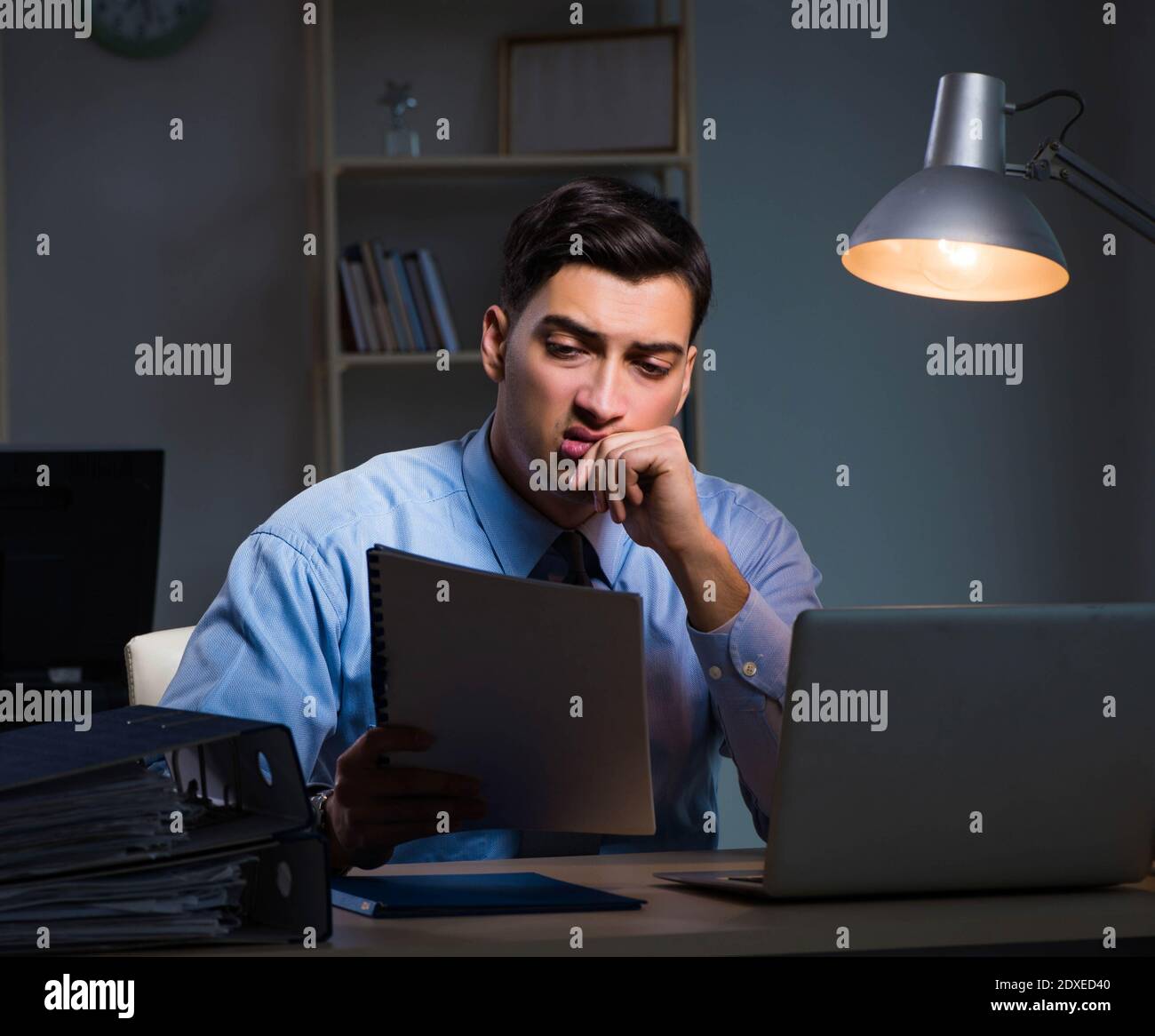 The employee working late at night at important report Stock Photo - Alamy
