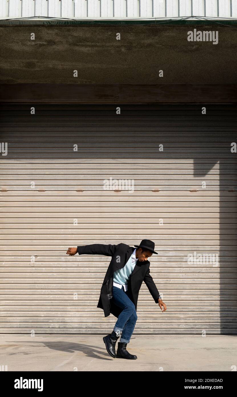 Happy young man dancing against shutter Stock Photo - Alamy