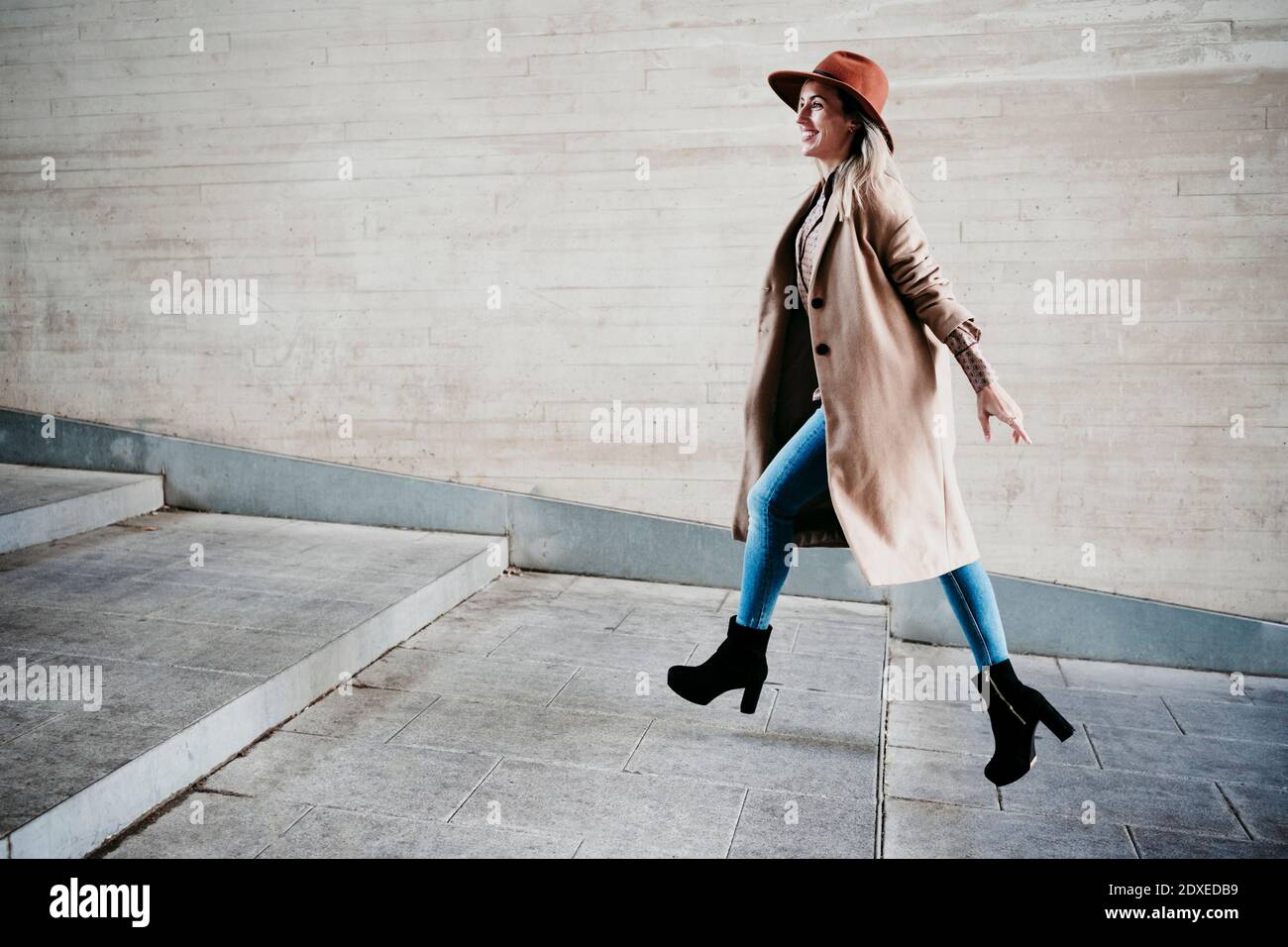 Woman up steps hi-res stock photography and images - Alamy