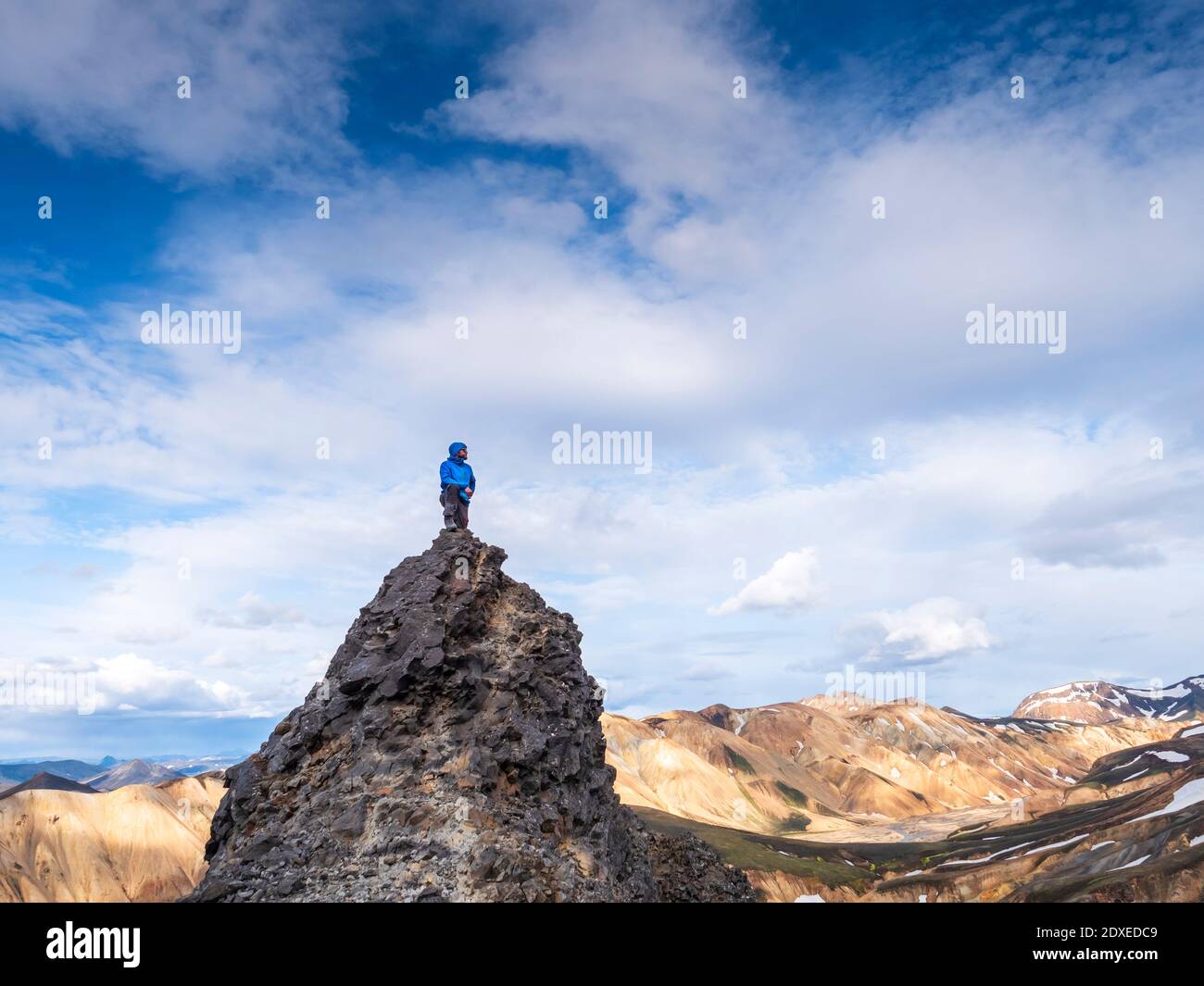 Hiker standing on top of volcanic hill in Landmannalaugar Stock Photo ...