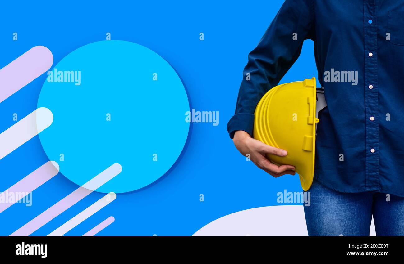 Engineer Blue Shirt Holding Hard hat helmet on Modern background light ...