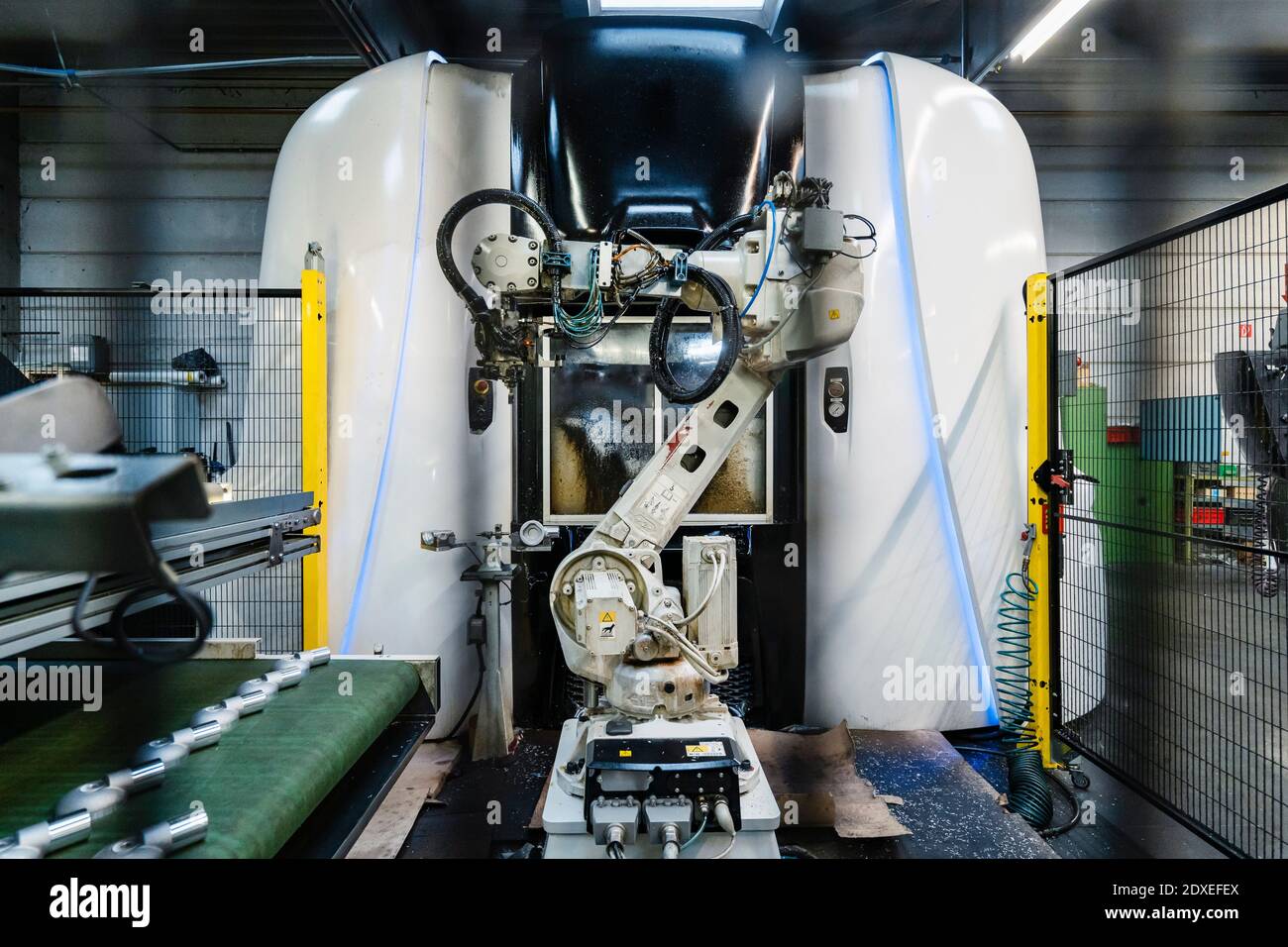 Automatic robotic arm against machinery in manufacturing industry Stock ...