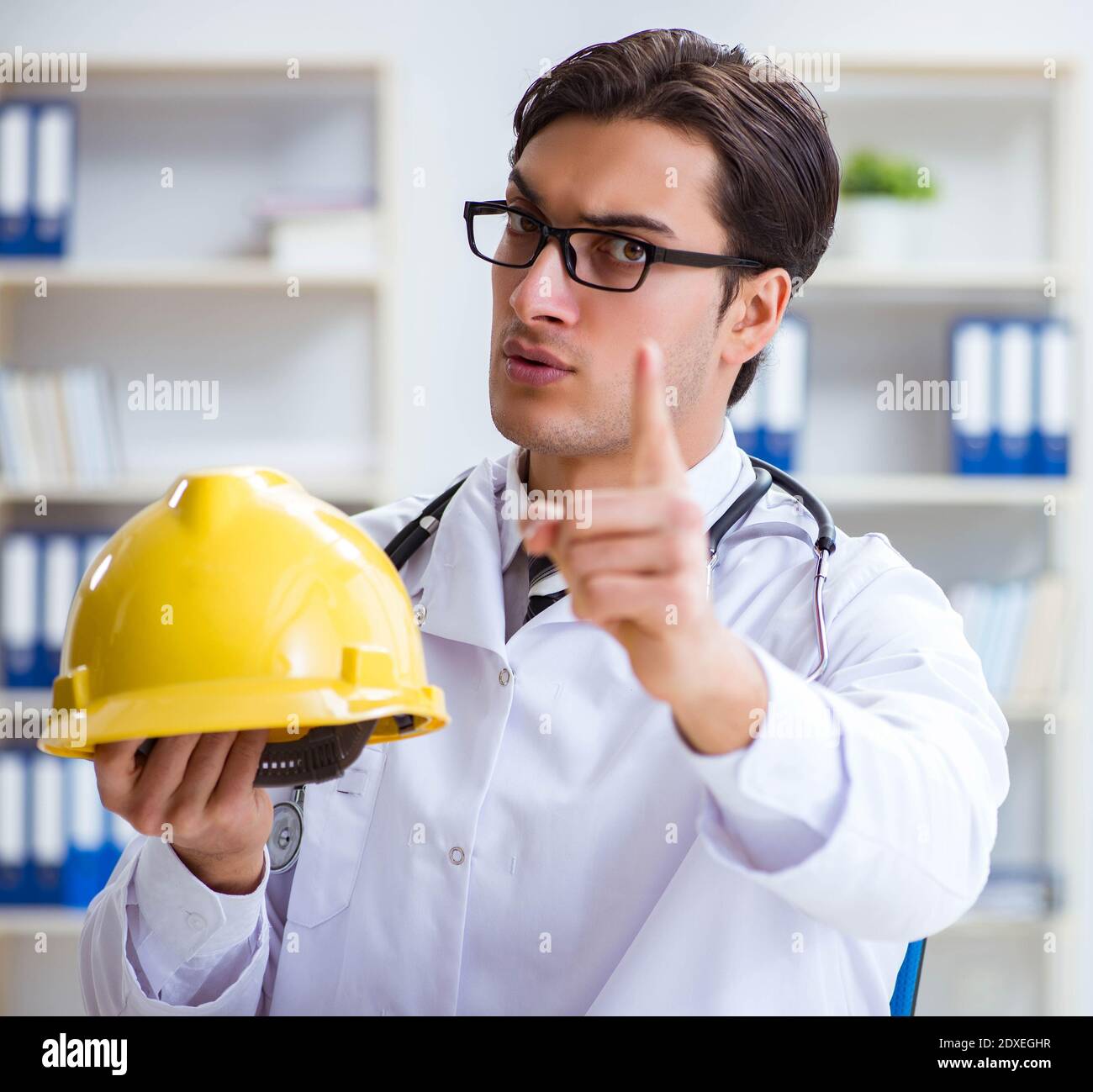 The safety doctor advising about wearing hard hat Stock Photo - Alamy