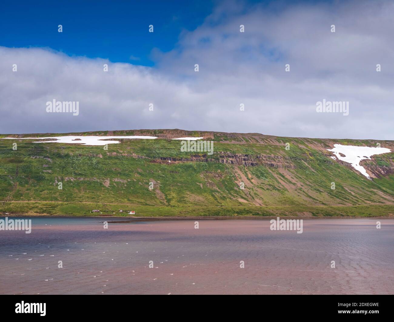 Secluded farm at foot of coastal hill in Westfjords Stock Photo - Alamy