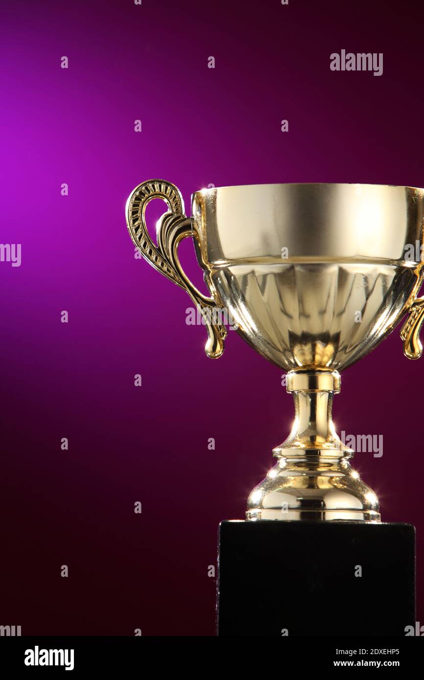 Close-up Of Silver Trophy Against Purple Background Stock Photo - Alamy