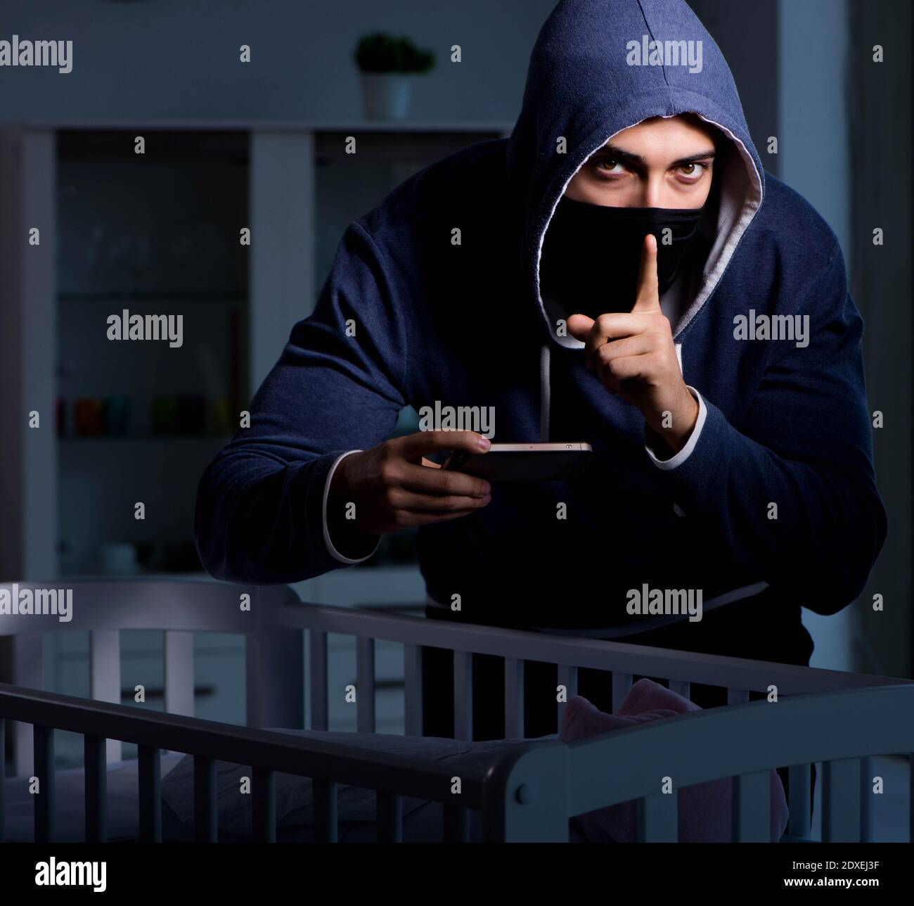 The criminal stealing baby in human child traficking concept Stock ...