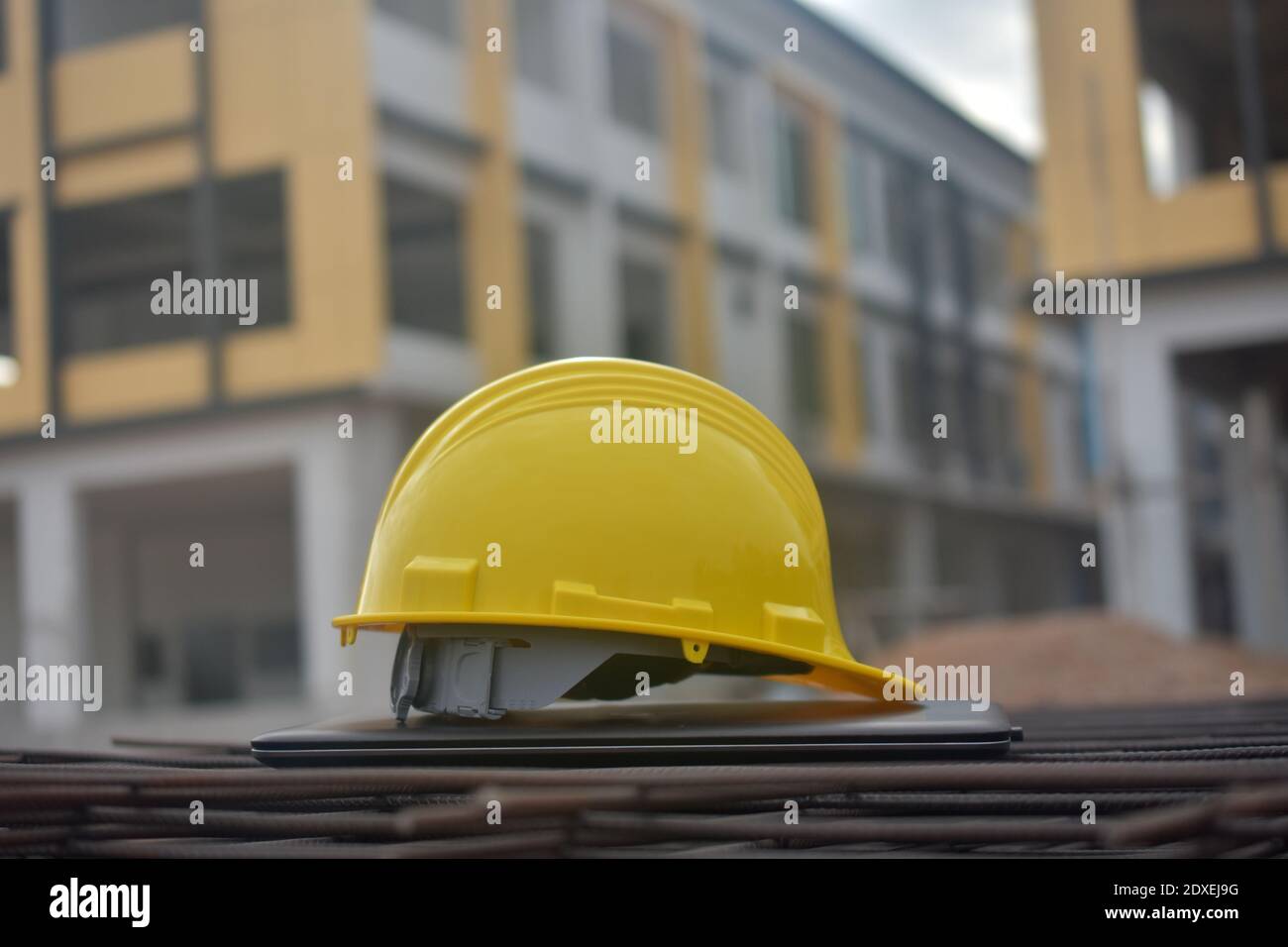 Yellow helmet hard hat safety building estate construction background ...