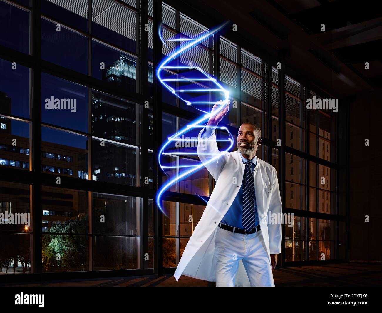 Mature male doctor light painting DNA in laboratory at hospital Stock ...