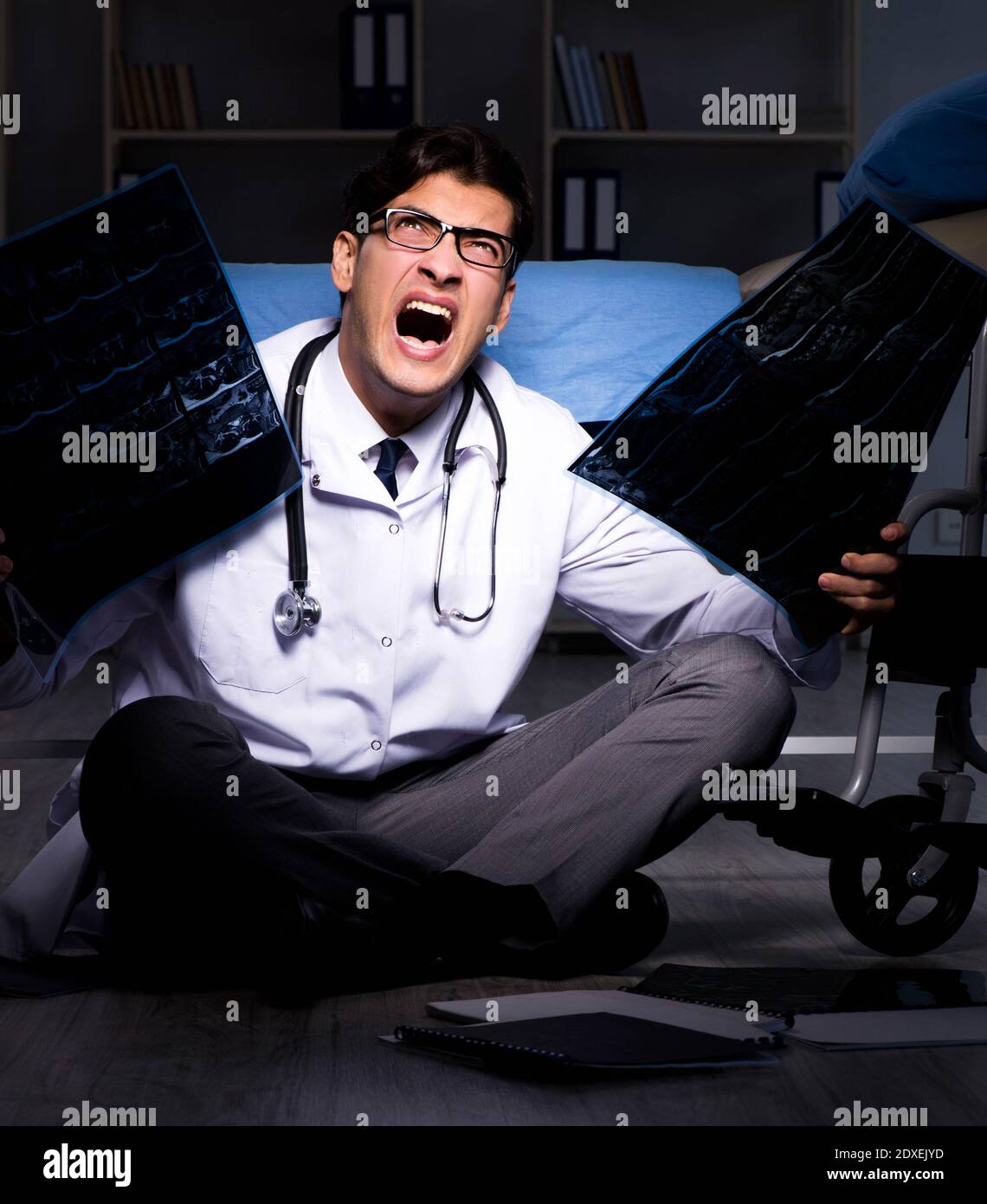 The doctor working night shift in hospital after long hours Stock Photo ...