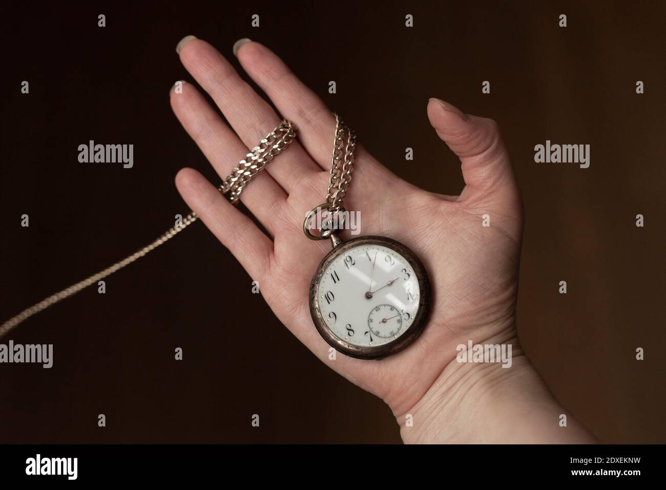 Hand holding pocket watch hi-res stock photography and images - Alamy