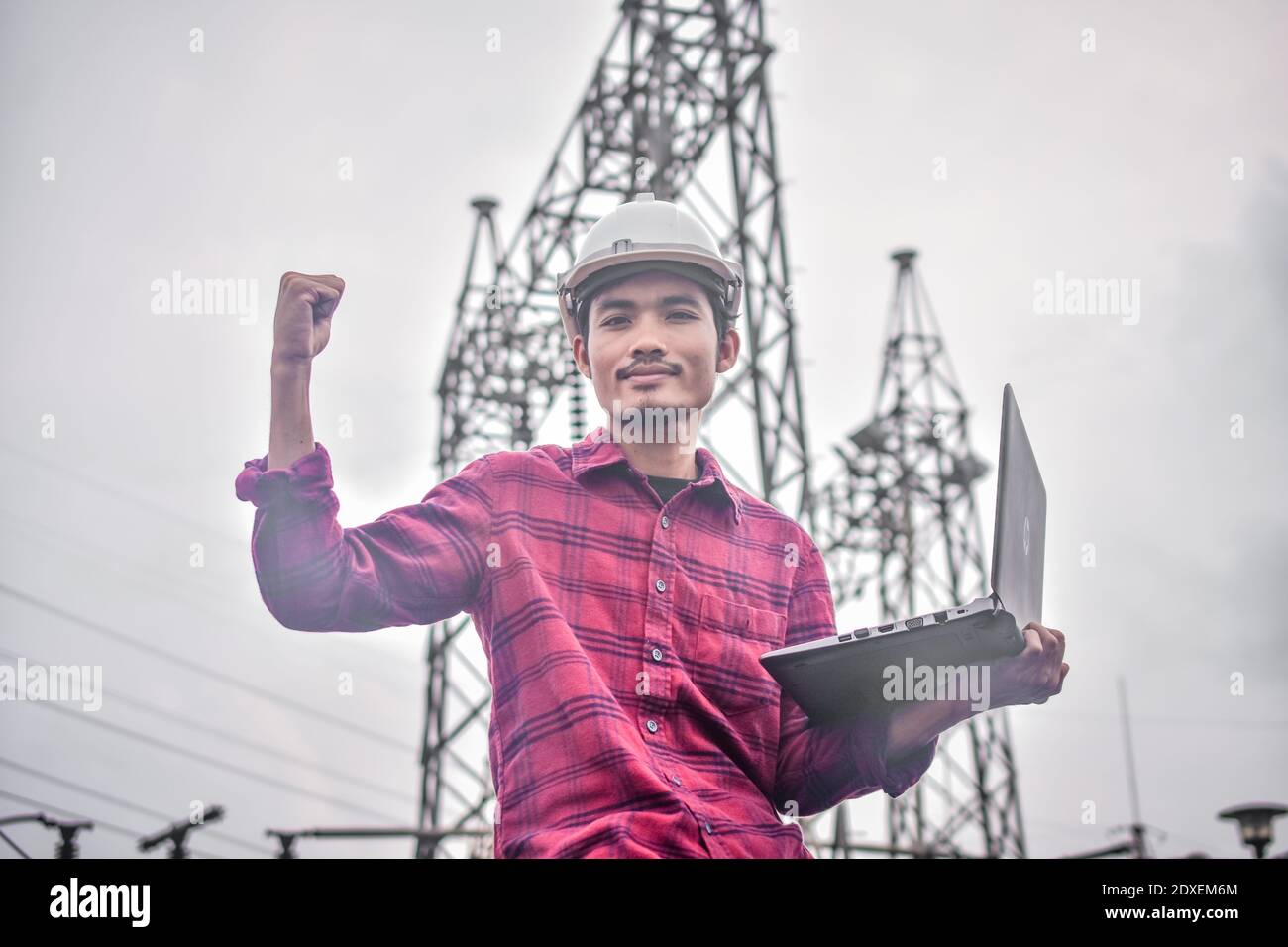 Electrical Engineering holding computer notebook inspection work power ...