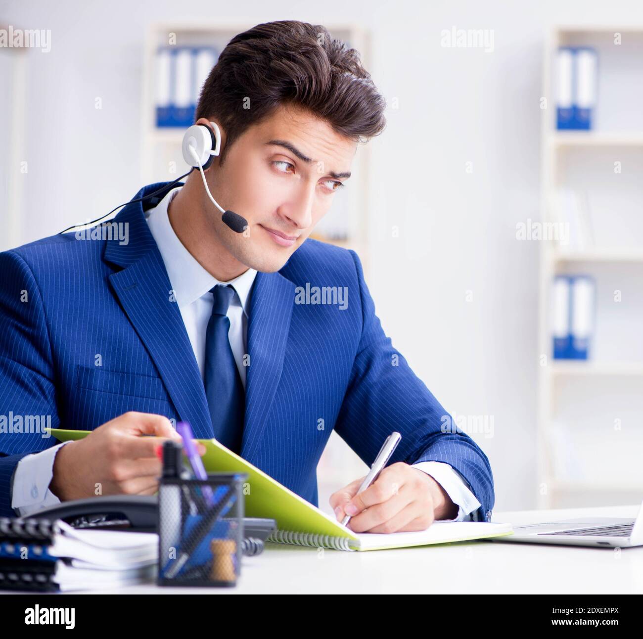 The young help desk operator working in office Stock Photo - Alamy