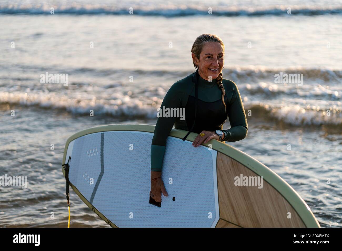 Smiling woman holding paddle hi-res stock photography and images - Alamy
