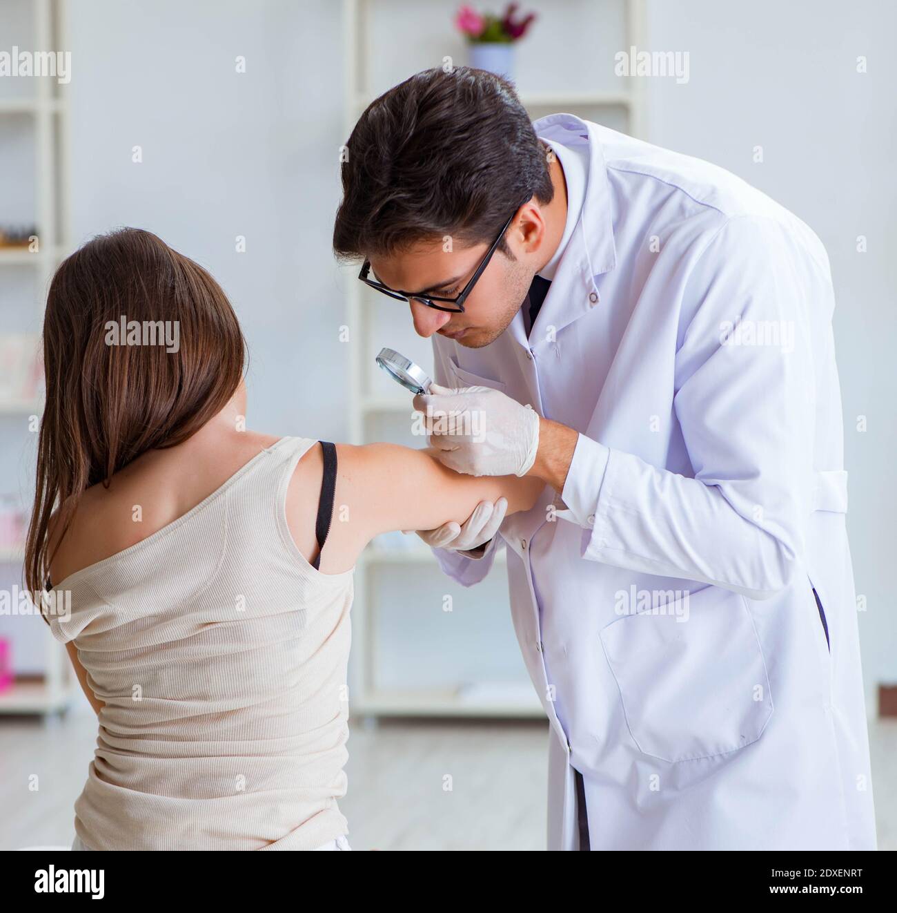 The doctor examining the skin of female patient Stock Photo - Alamy