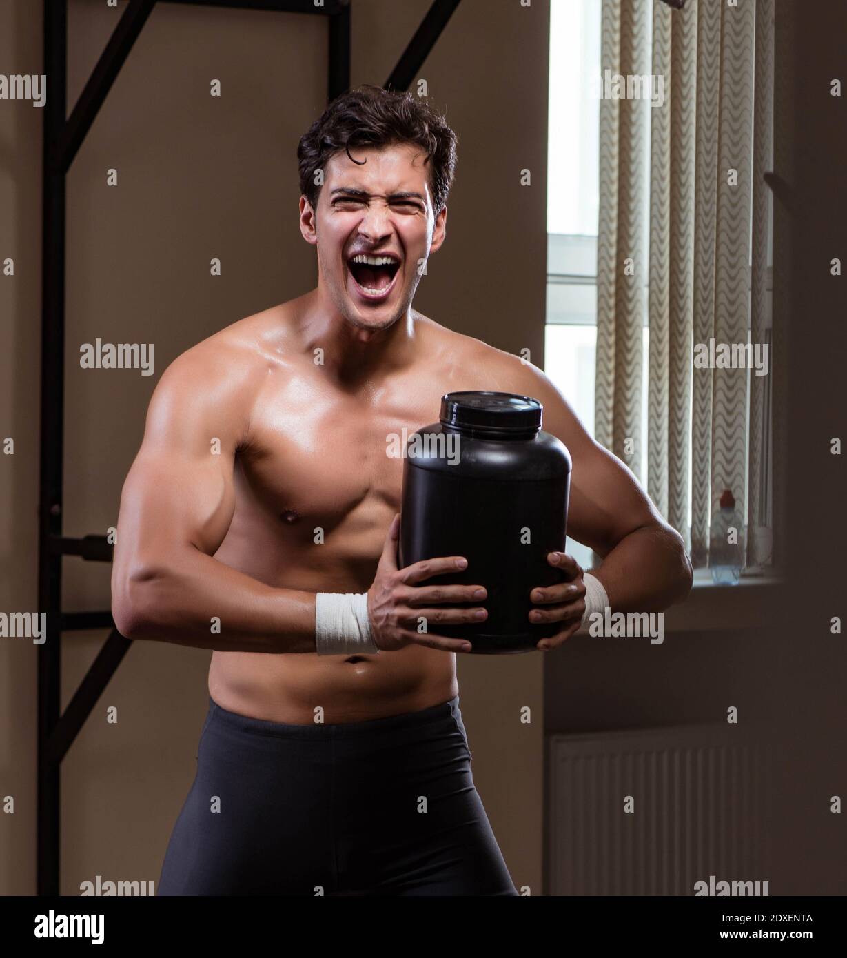 The man with nutrient supplements in sports gym Stock Photo - Alamy